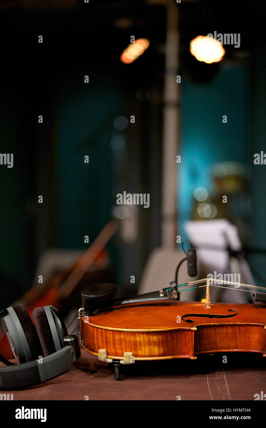 Violin laying on table inside music studio Stock Photo - Alamy