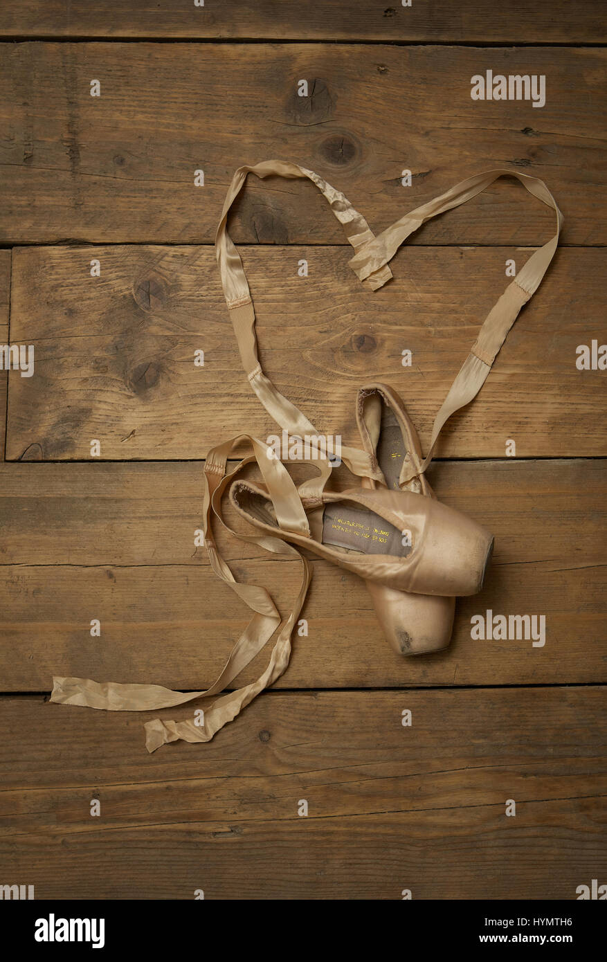 Top view of a pair of ballet shoes with ribbons making heart shape ...
