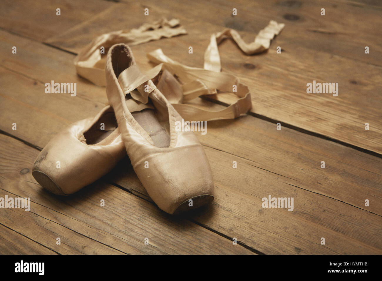 Two ballet shoes on wooden floor Stock Photo - Alamy