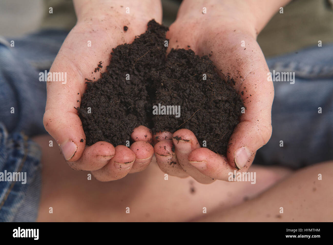Child hands holding soil in hands - close up Stock Photo - Alamy