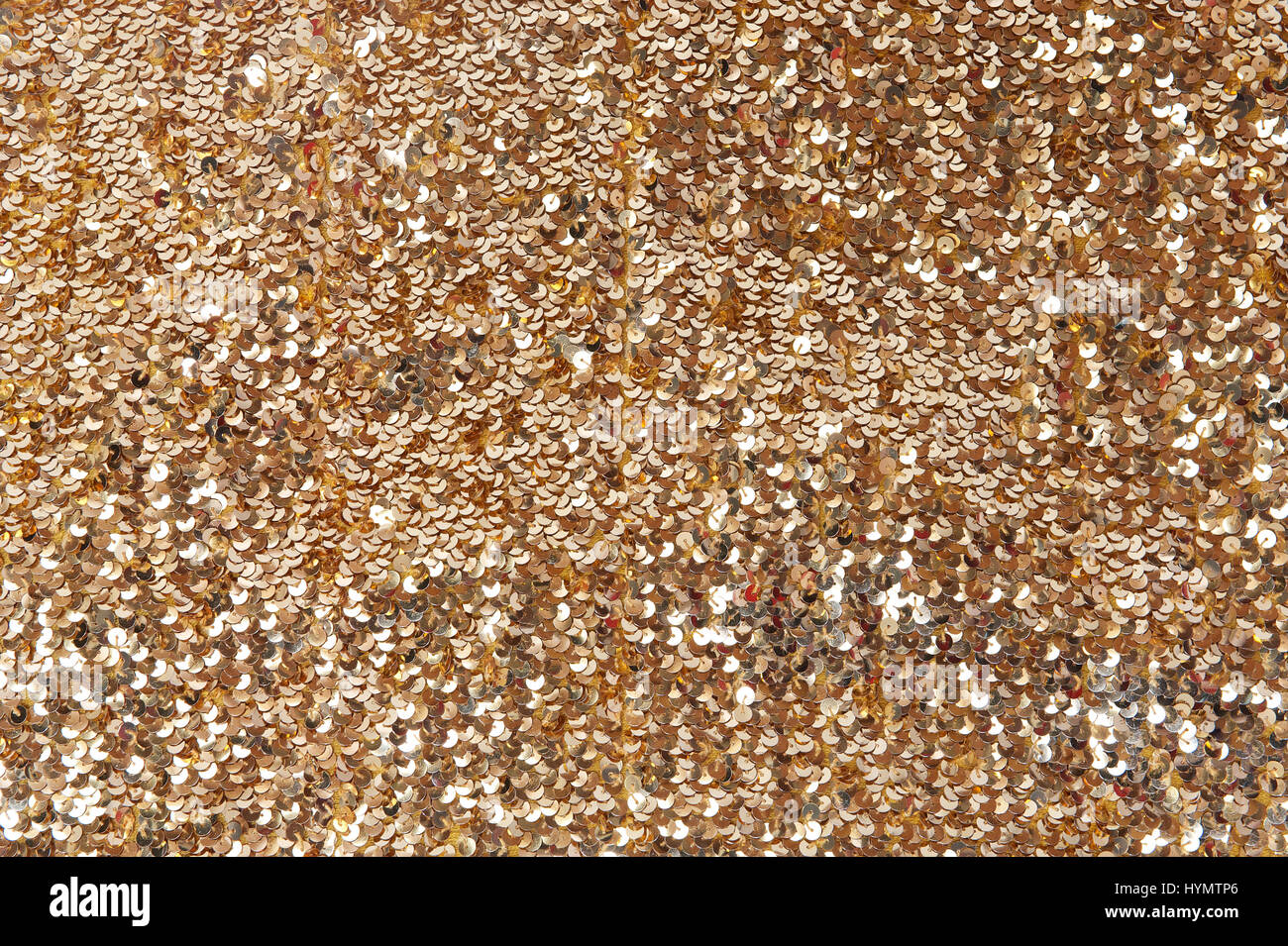 Close up of many shiny gold sequins Stock Photo - Alamy