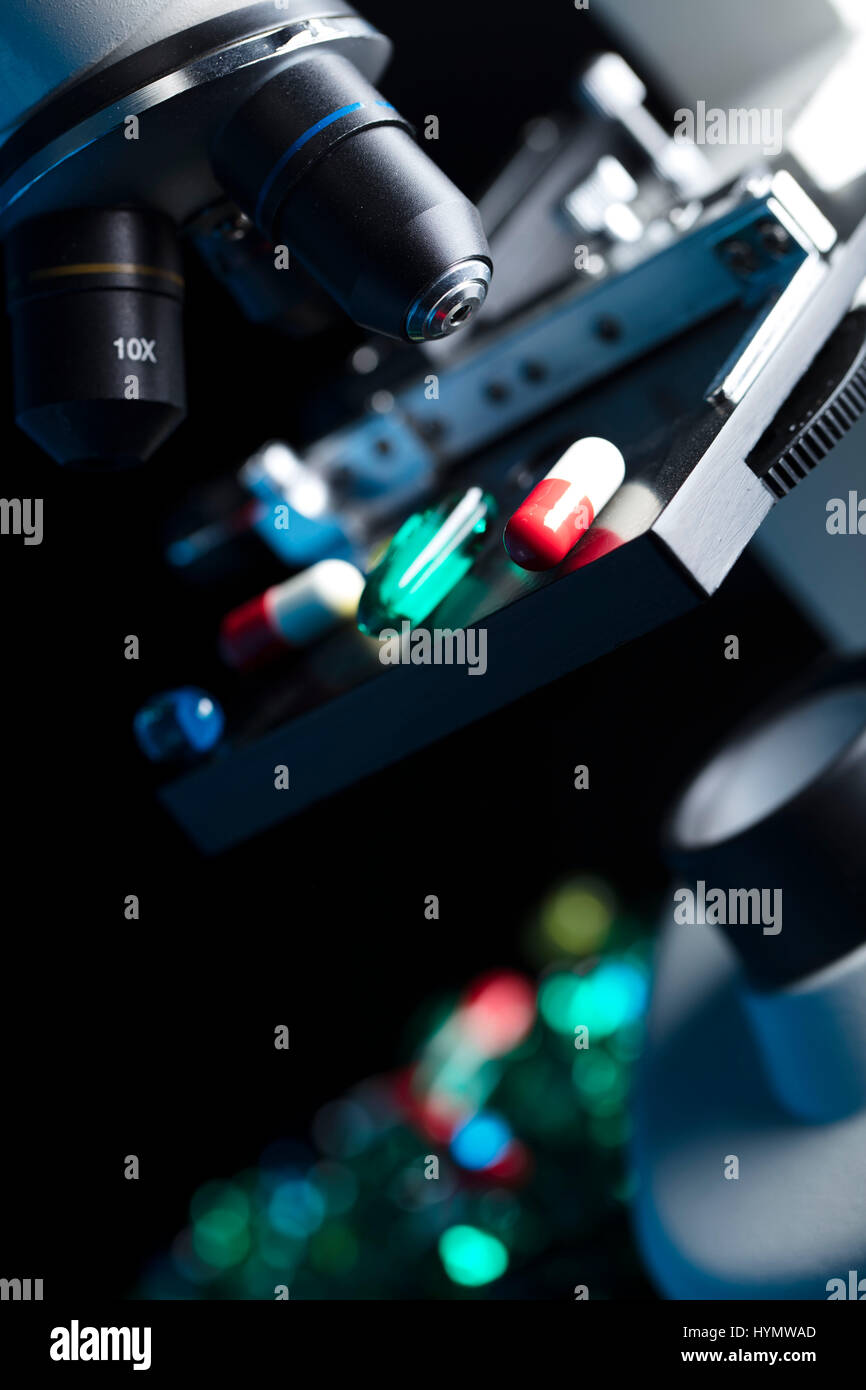 Pharmacy theme. Set of different colorful pills. Microscope in ...