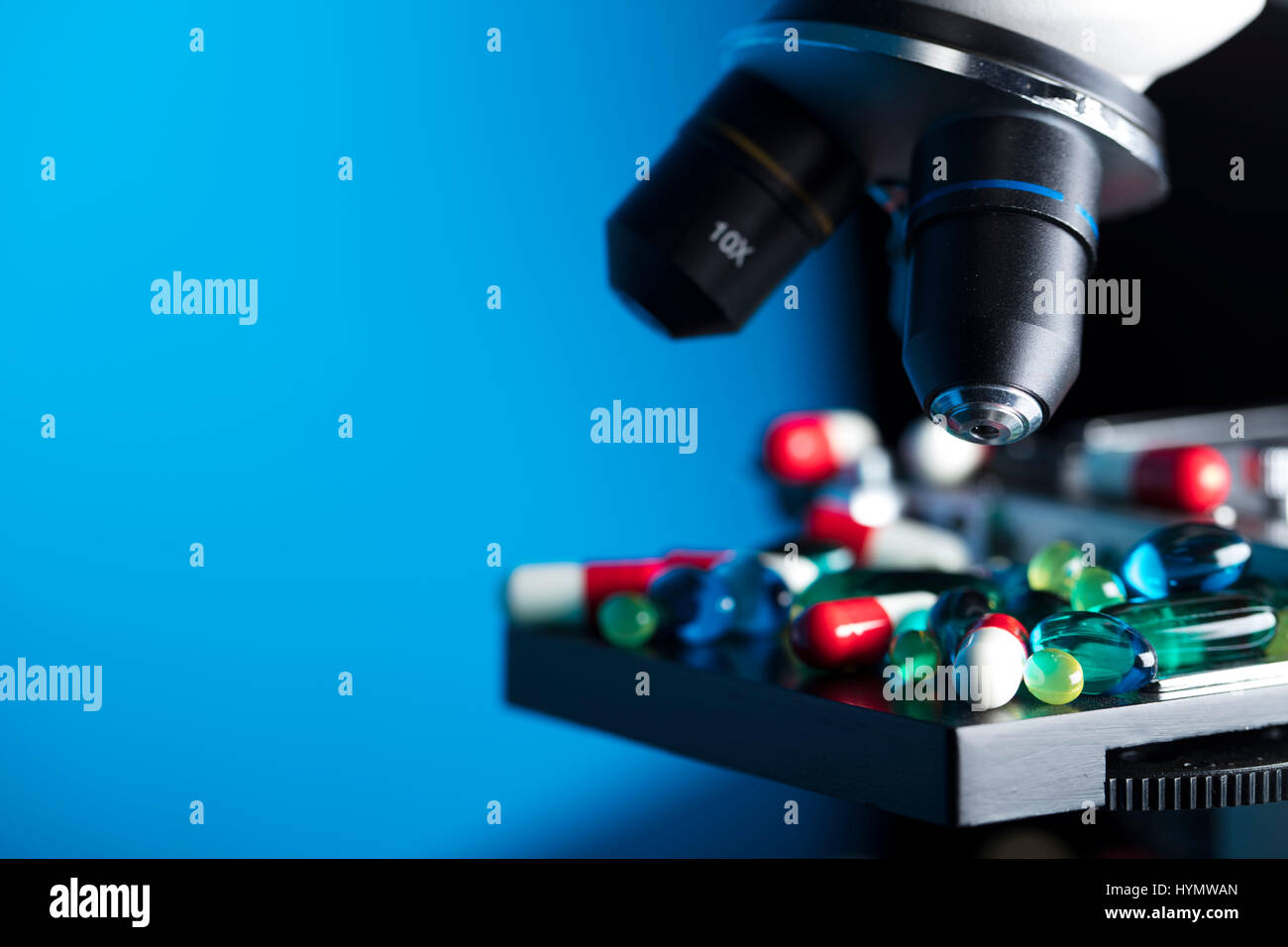 Pharmacy theme. Set of different colorful pills. Microscope in ...