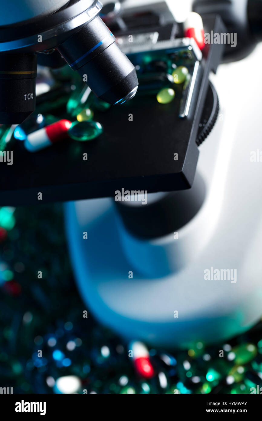 Pharmacy theme. Set of different colorful pills. Microscope in ...