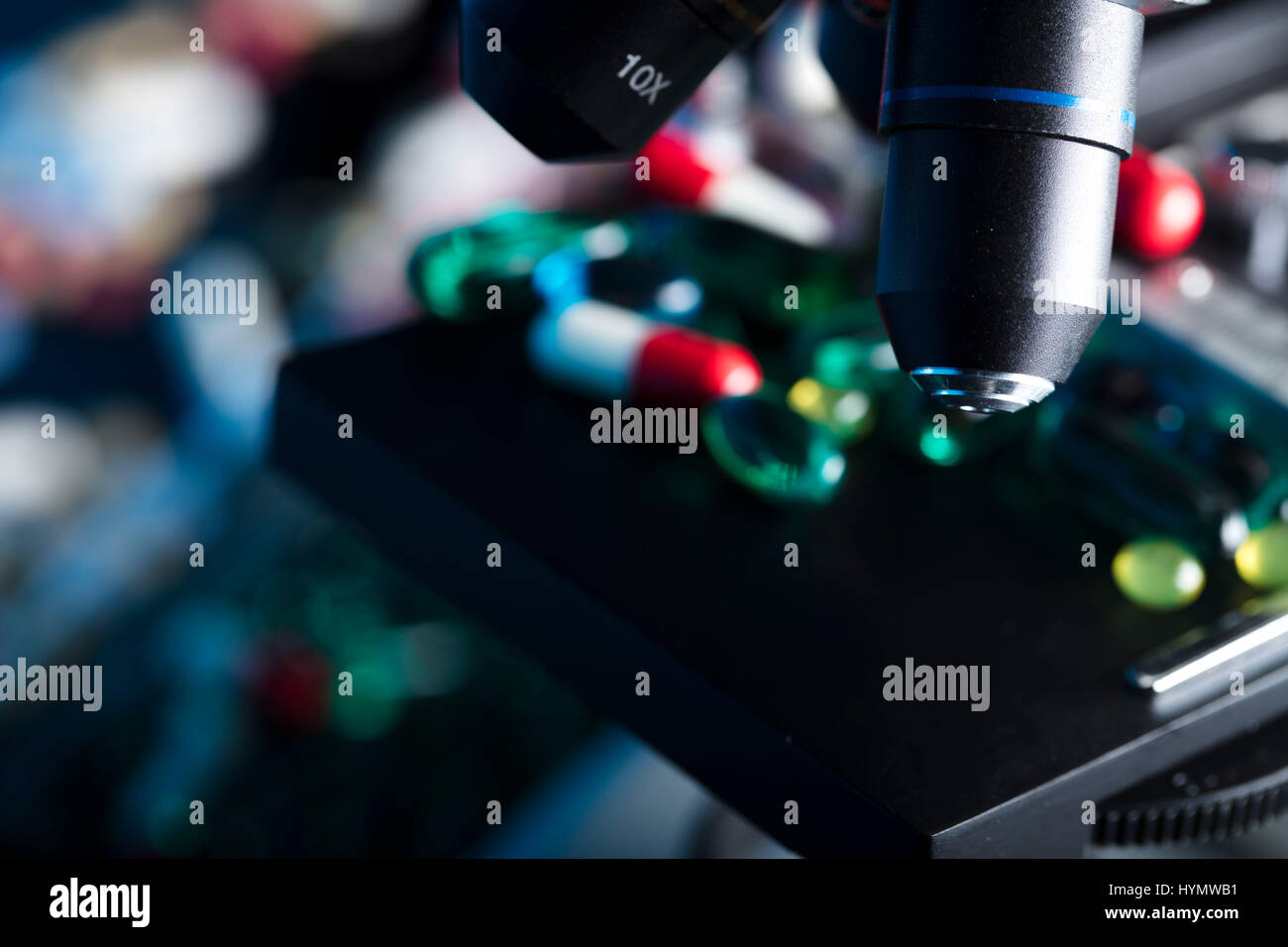 Pharmacy theme. Set of different colorful pills. Microscope in ...