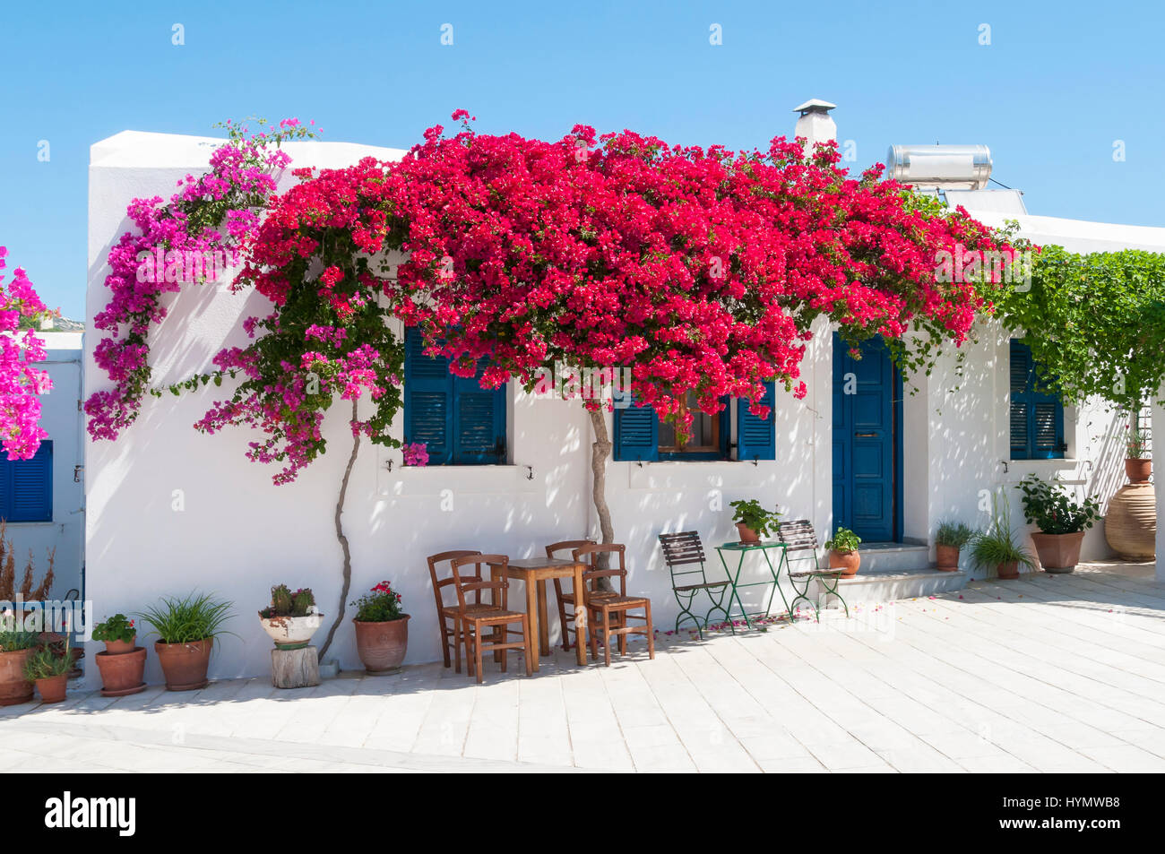 A Greek terrace with typical wooden chairs on the island of Paros. The ...
