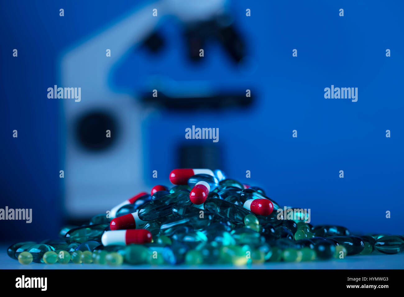 Pharmacy theme. Set of different colorful pills. Microscope in ...