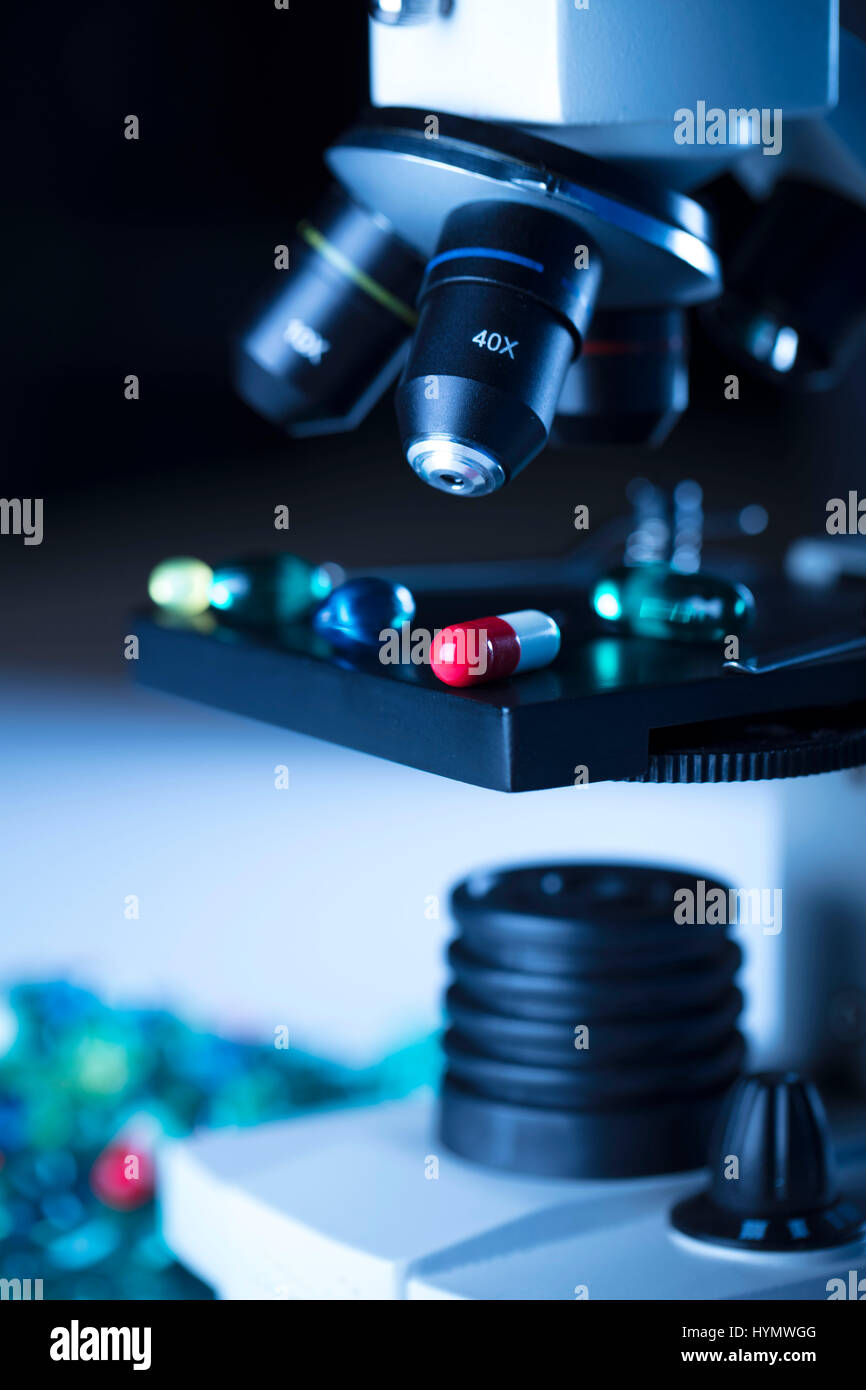 Pharmacy theme. Set of different colorful pills. Microscope in ...