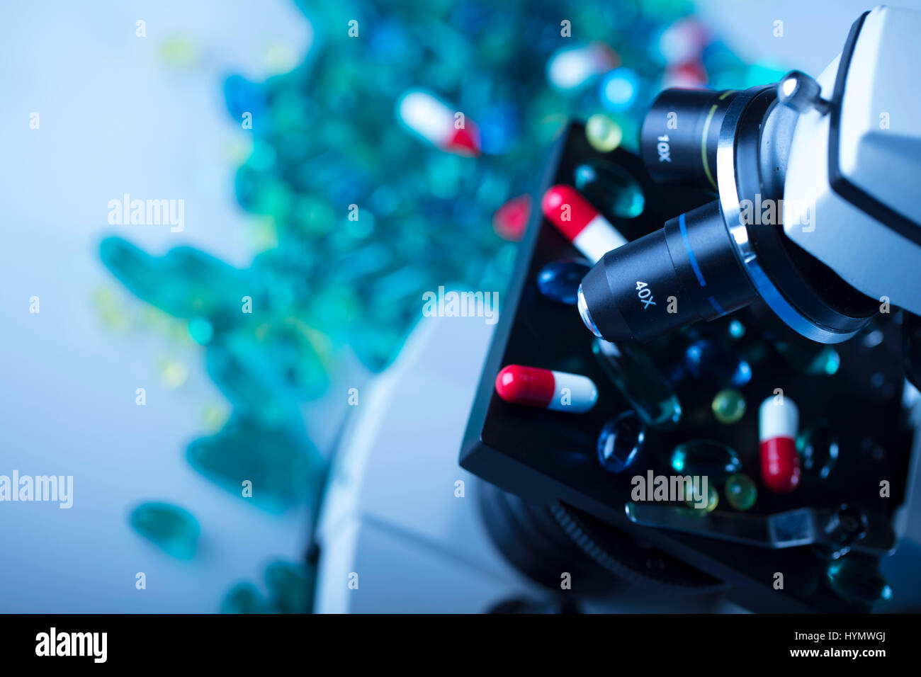 Pharmacy theme. Set of different colorful pills. Microscope in ...