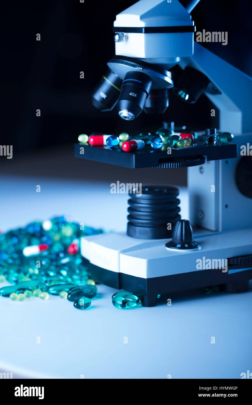 Pharmacy theme. Set of different colorful pills. Microscope in ...