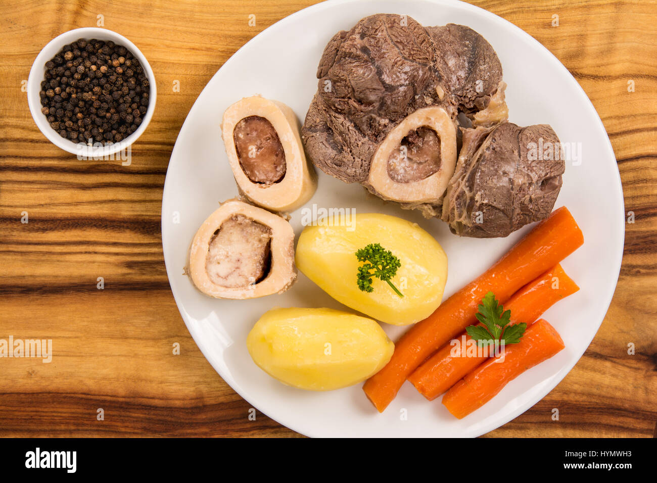 High angle view of a pot au feu, a french beef stew on a white plate ...