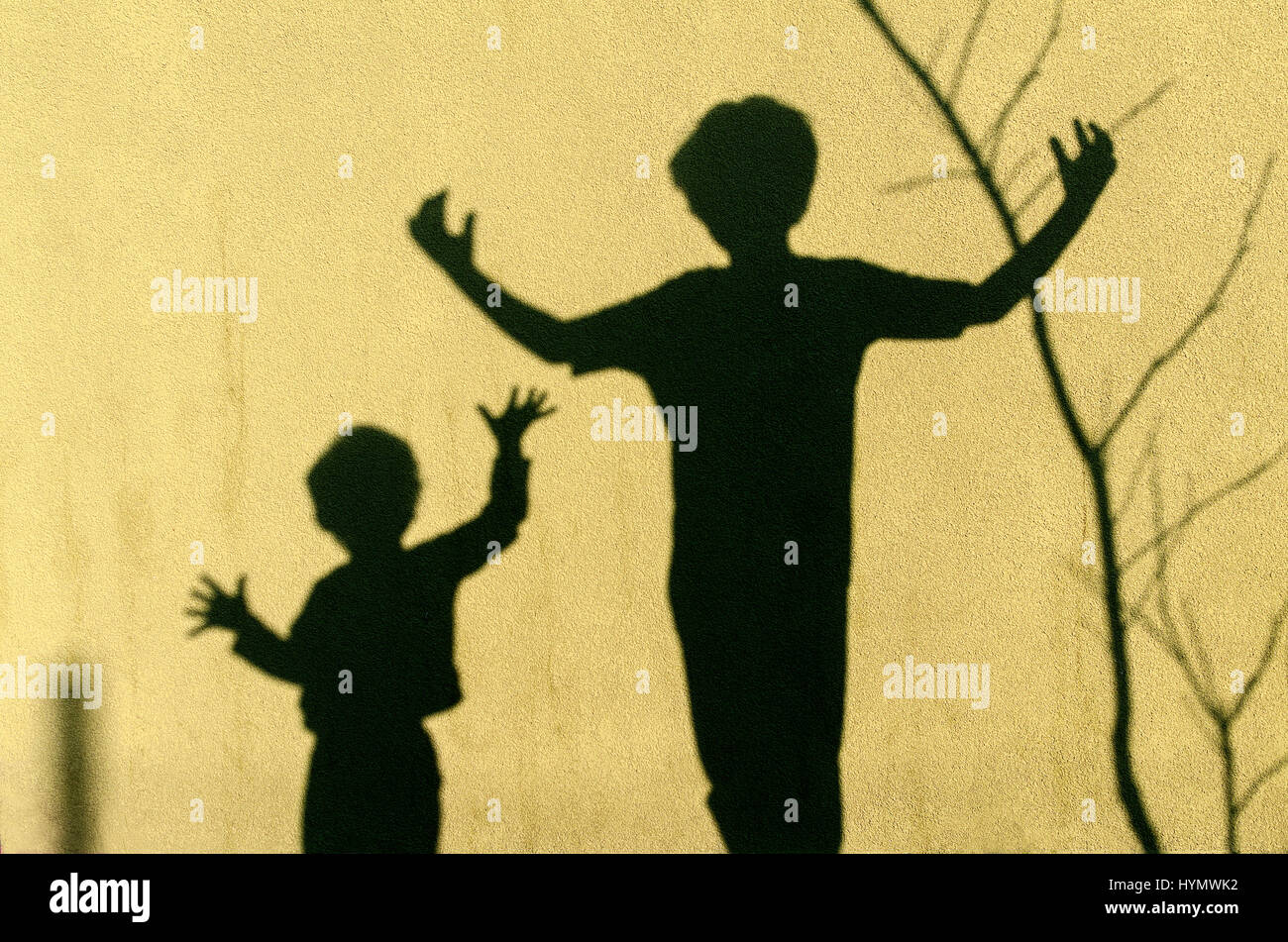 Shadows of children playing on the wall. Hands up Stock Photo - Alamy