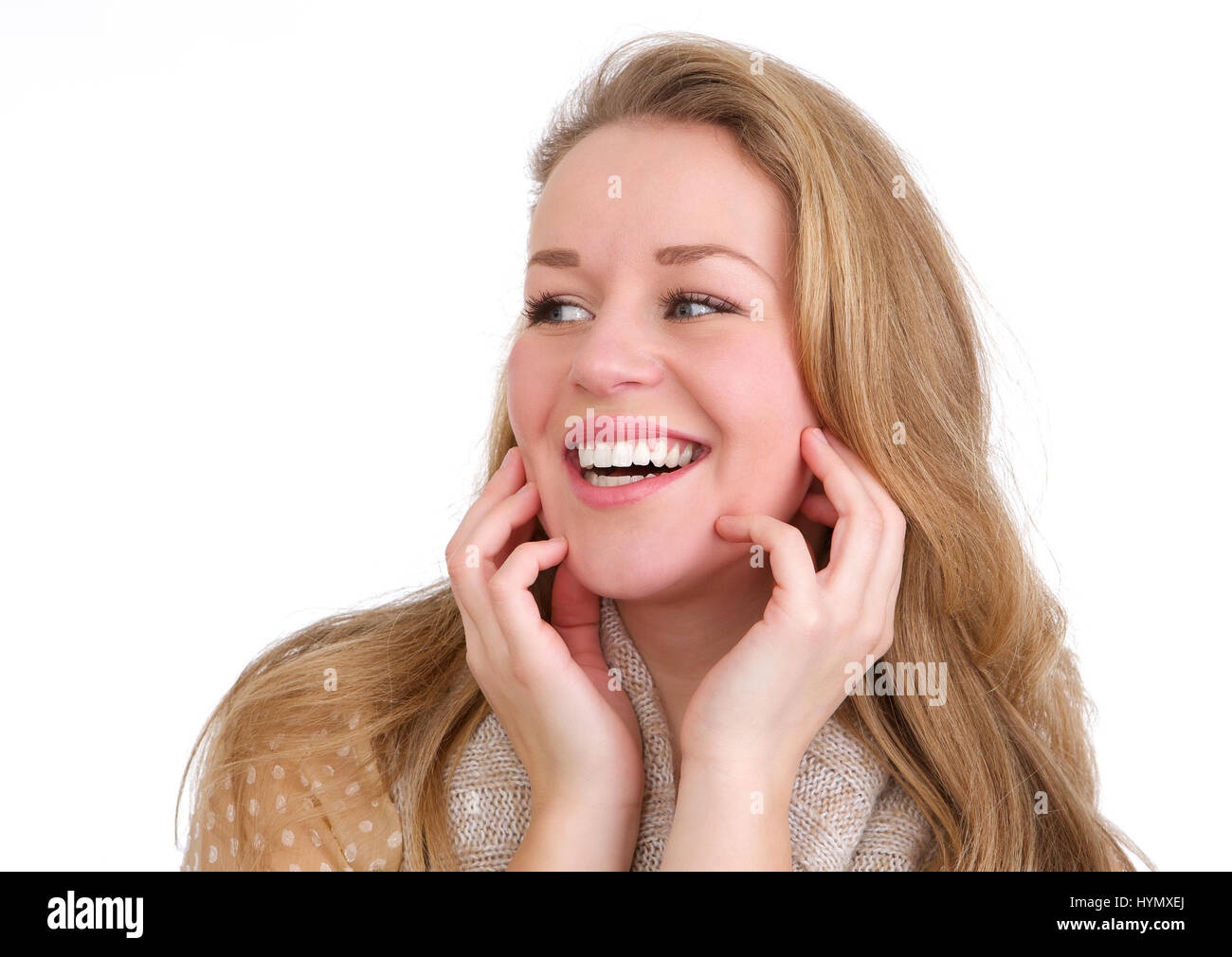 Close up portrait of a young woman laughing with hands to face on ...