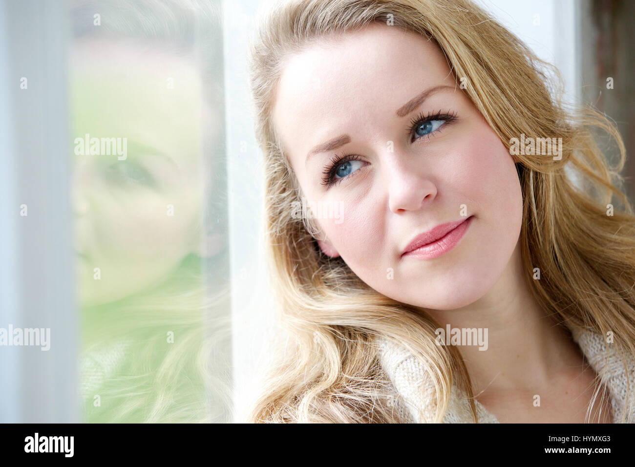 Close up portrait of a young woman gazing out window Stock Photo - Alamy