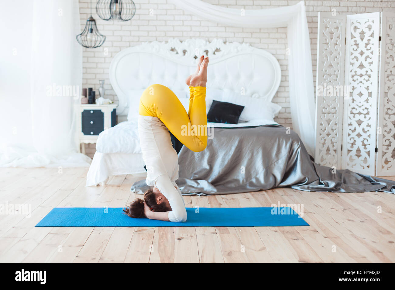 Woman standing on her head, she goes in for sports in the morning Stock ...