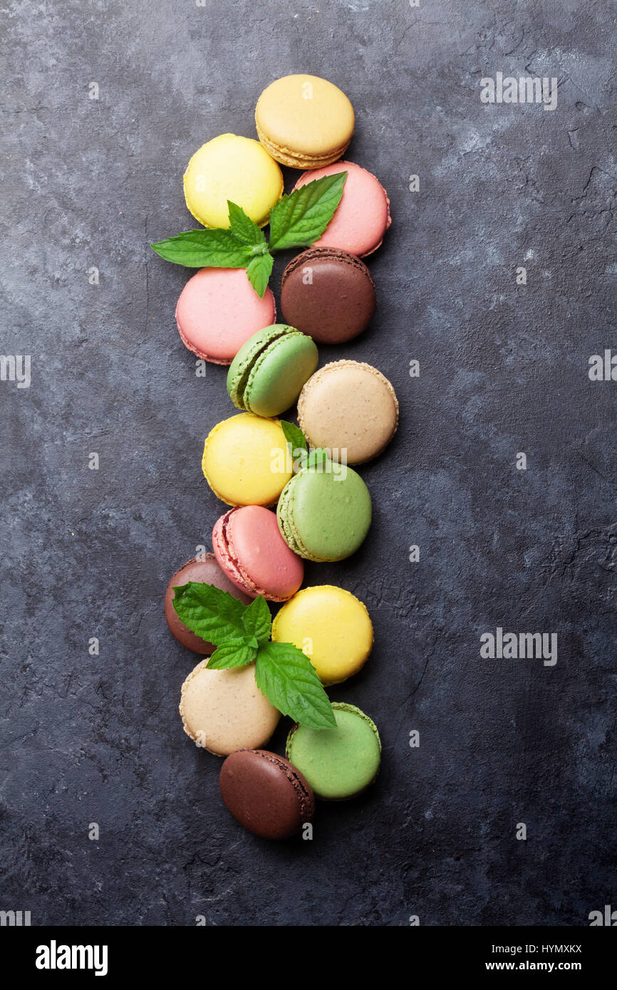 Colorful macaroons on stone table. Sweet macarons. Top view with copy ...