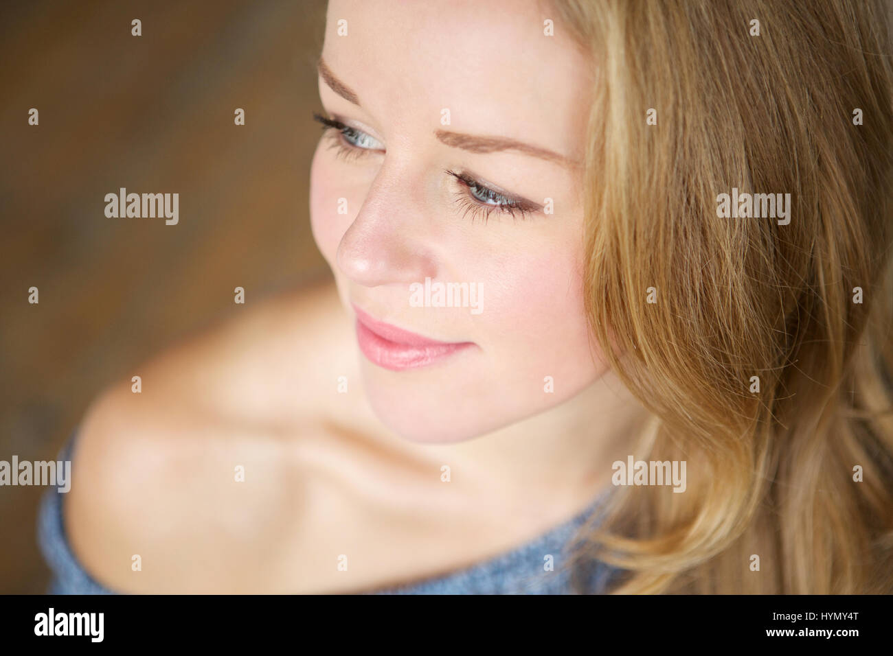 Close up portrait of a young woman smiling - side view Stock Photo - Alamy
