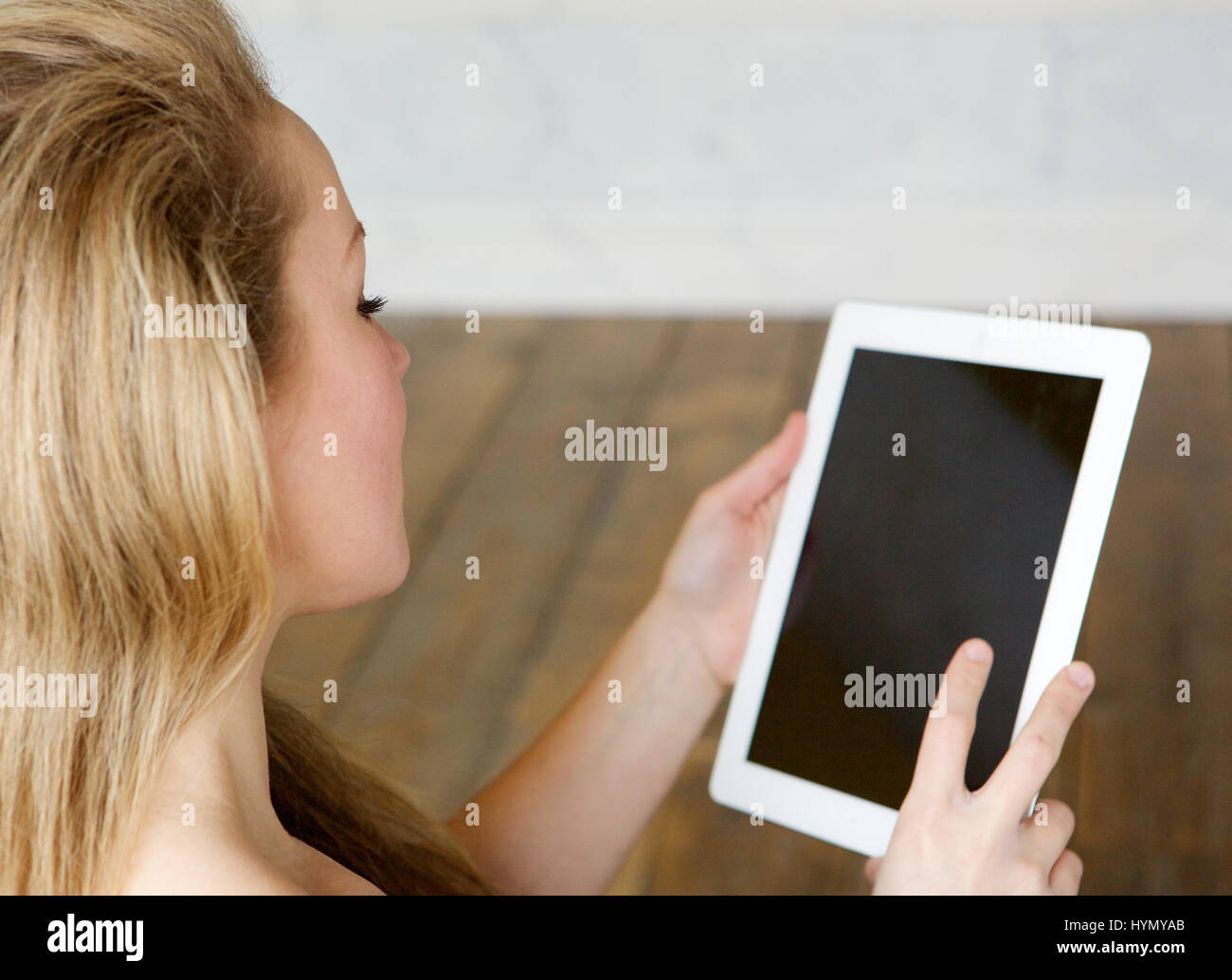 Close up portrait of a woman looking computer tablet screen Stock Photo ...