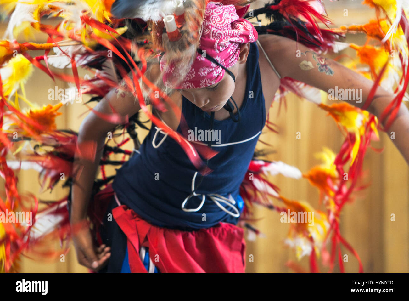 A young boy performs a traditional Native American dance while dressed ...
