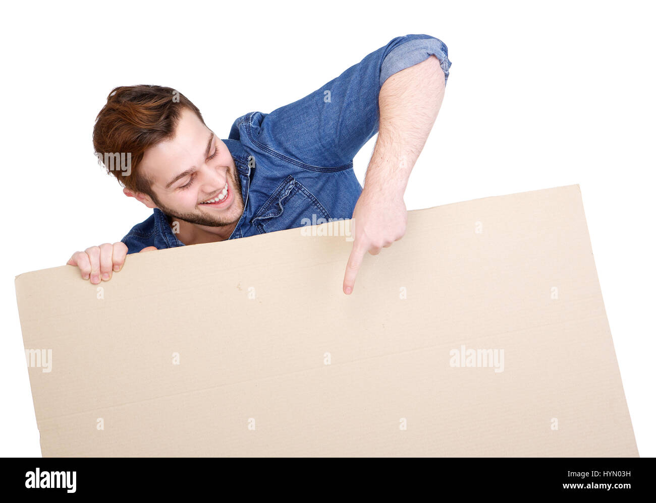 Portrait of a smiling man pointing finger on blank poster sign Stock ...