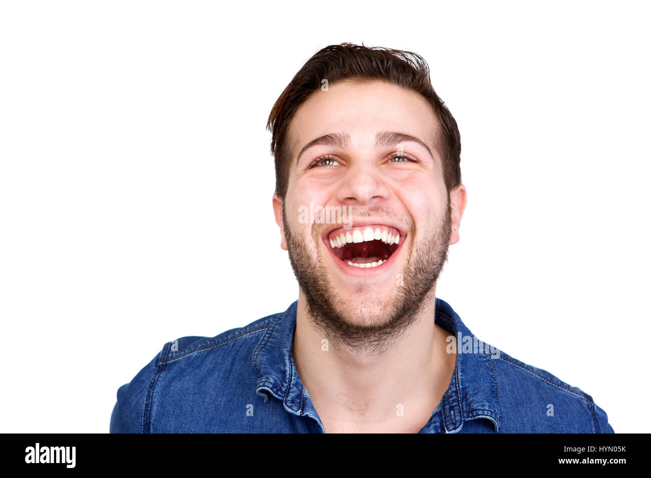Close up horizontal portrait of a cheerful young man laughing and ...