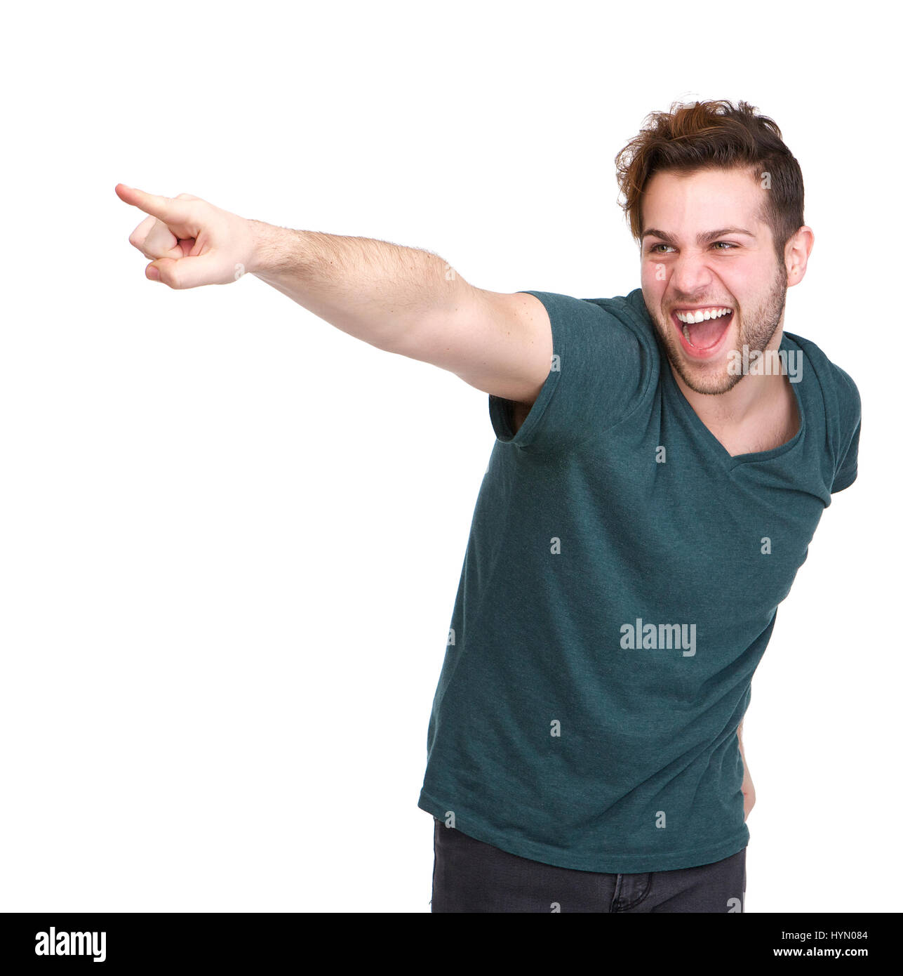 Portrait of a handsome young man smiling and pointing finger on ...