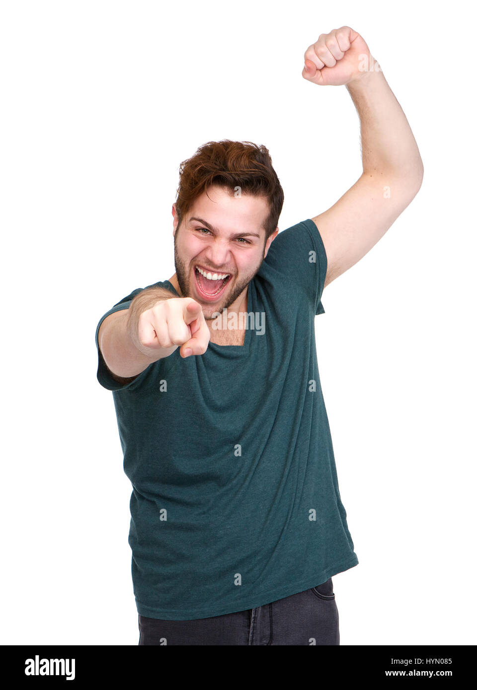 Portrait of a cheerful young man pointing finger on isolated white ...