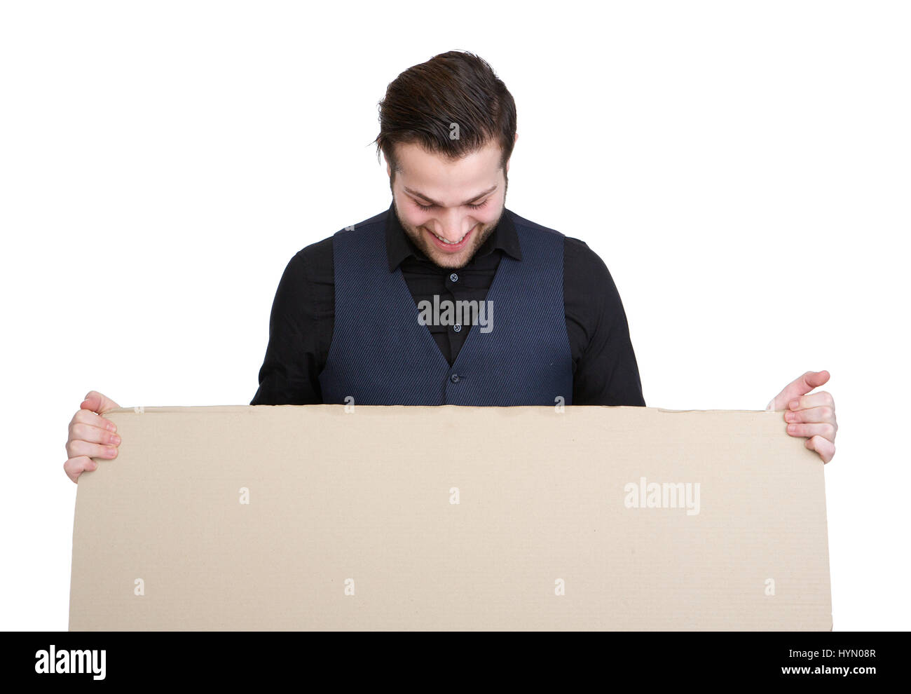 Portrait of a young man looking down at blank poster on isolated white ...