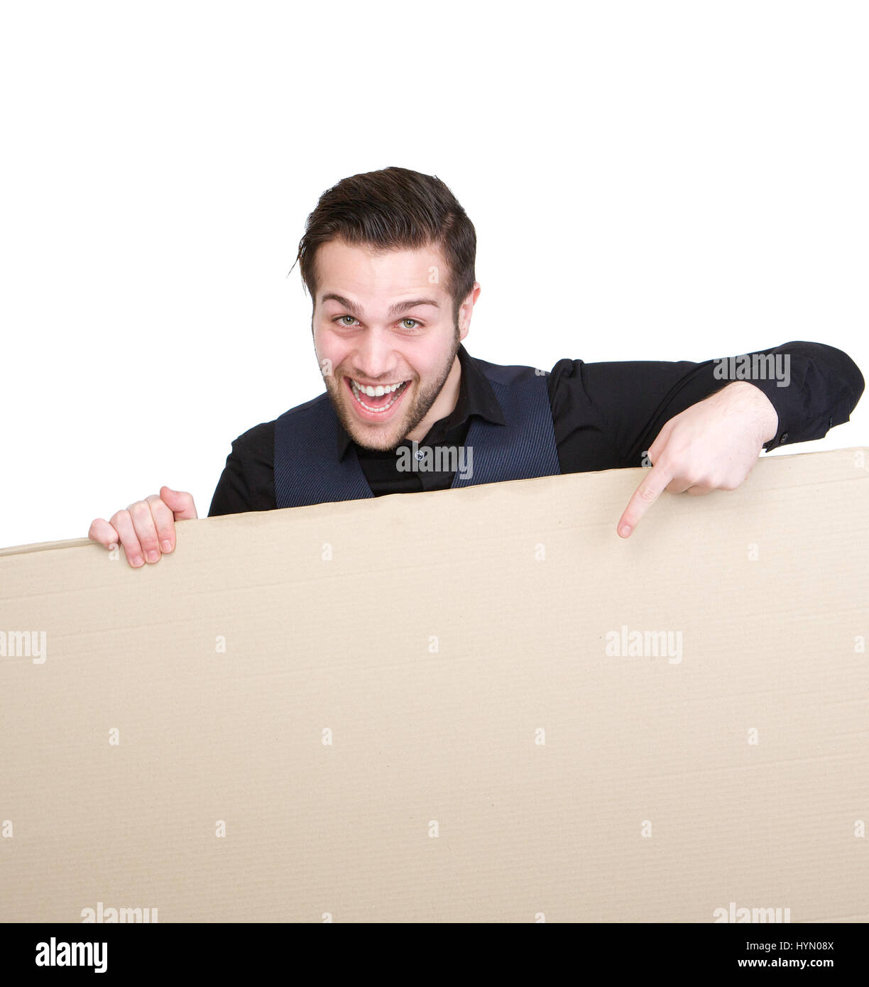 Portrait of a young man laughing and pointing finger showing blank ...