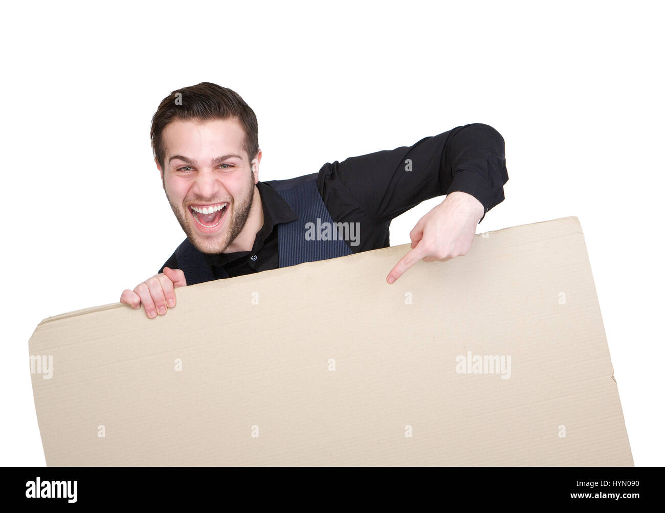 Portrait of a handsome smiling young man pointing finger to blank ...