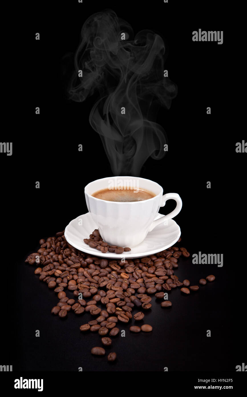 White cup with hot liquid and steam on black Stock Photo - Alamy