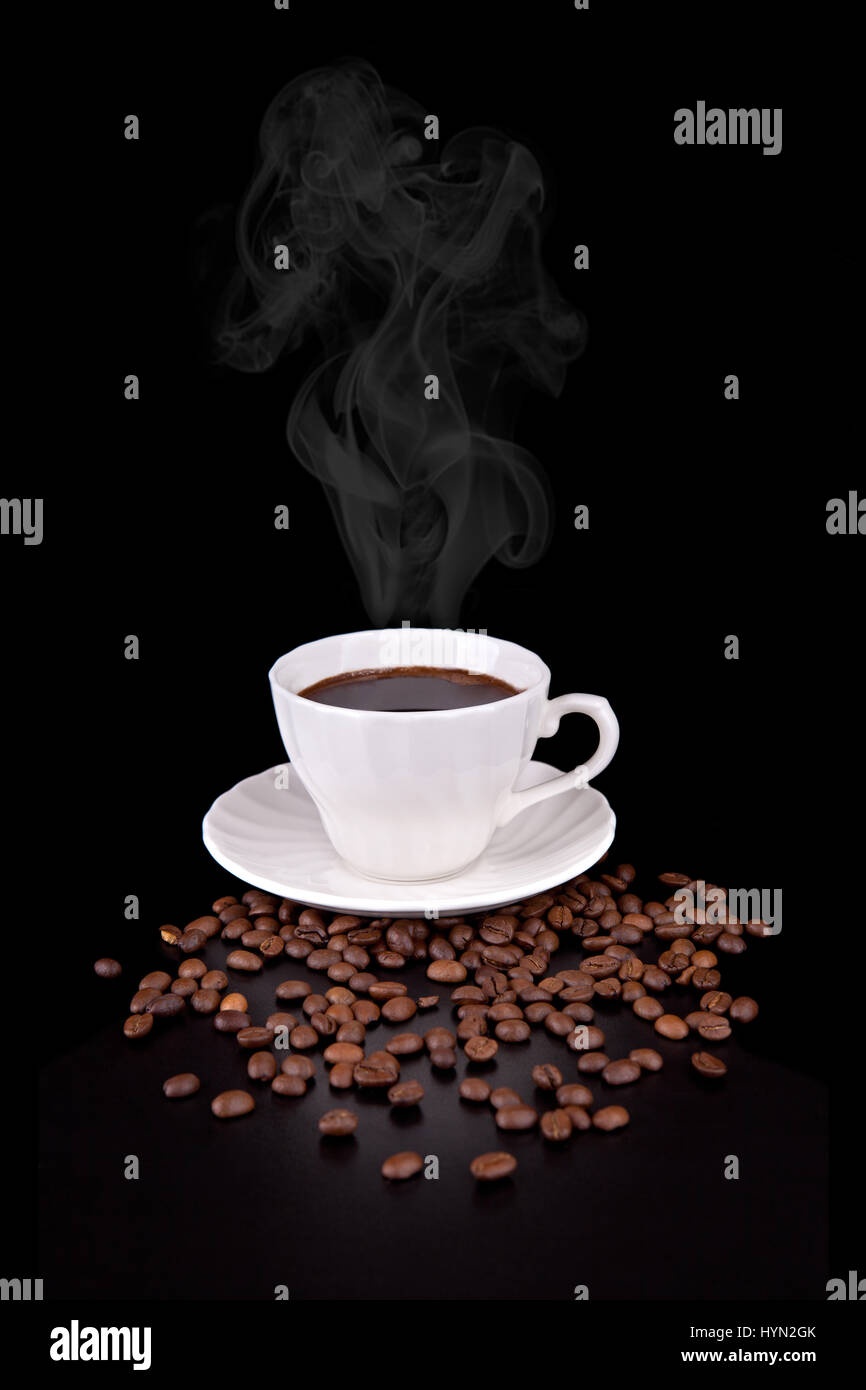 White cup with hot liquid and steam on black Stock Photo - Alamy