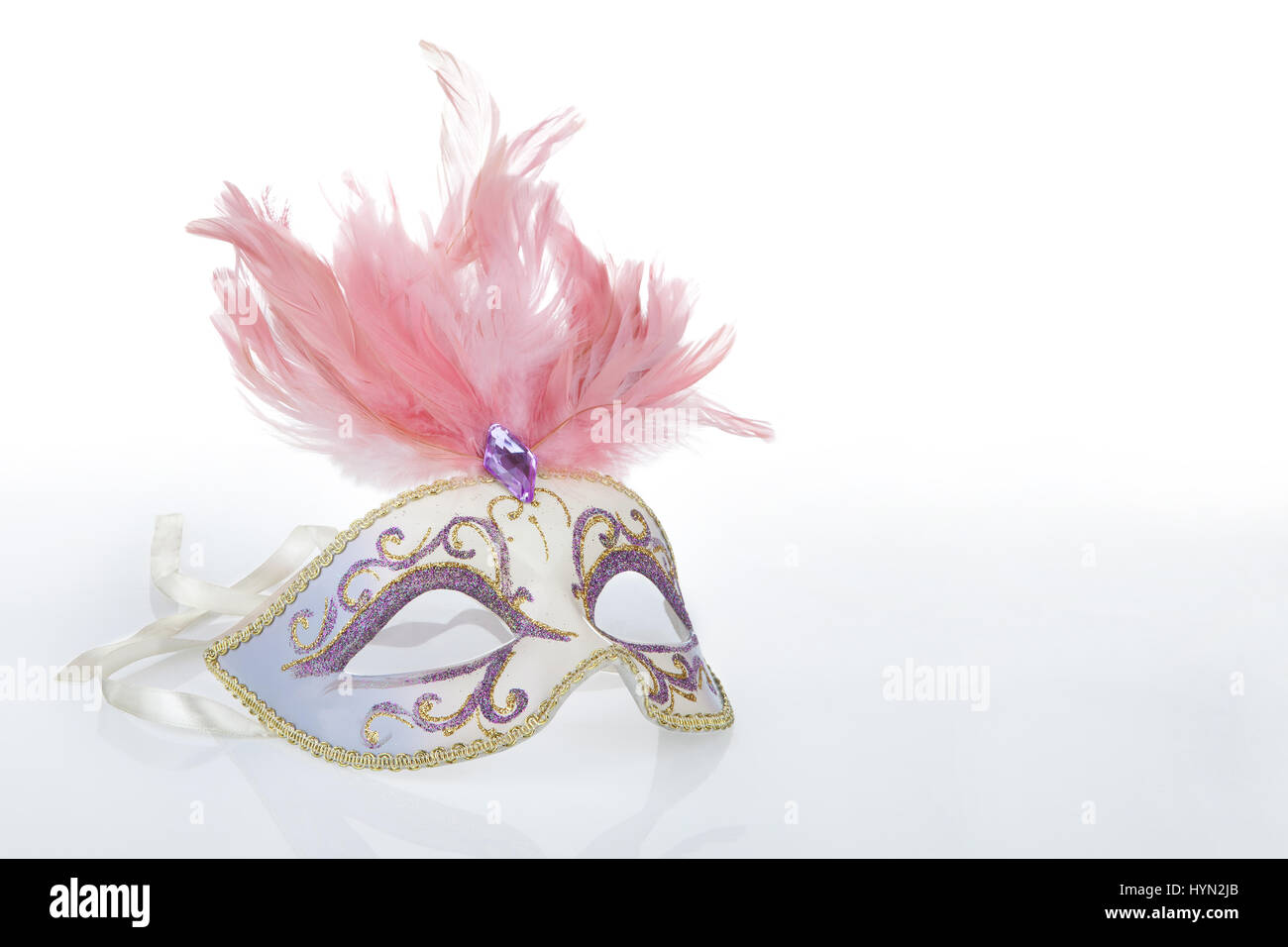 Beautiful carnival mask with pink feathers and a reflection, copy space ...