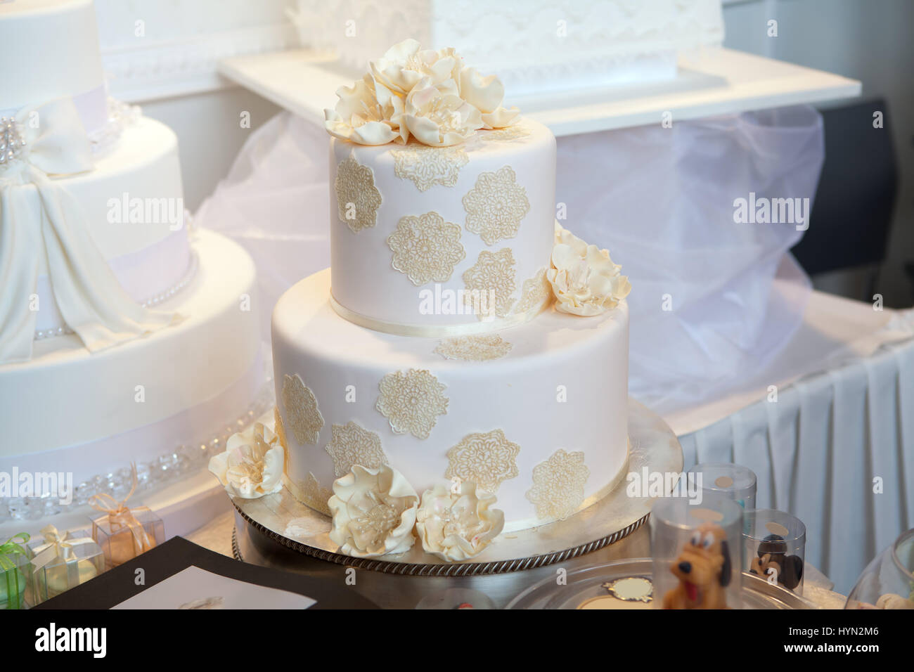 Elegant White Wedding Cake with Beige flowers Stock Photo - Alamy