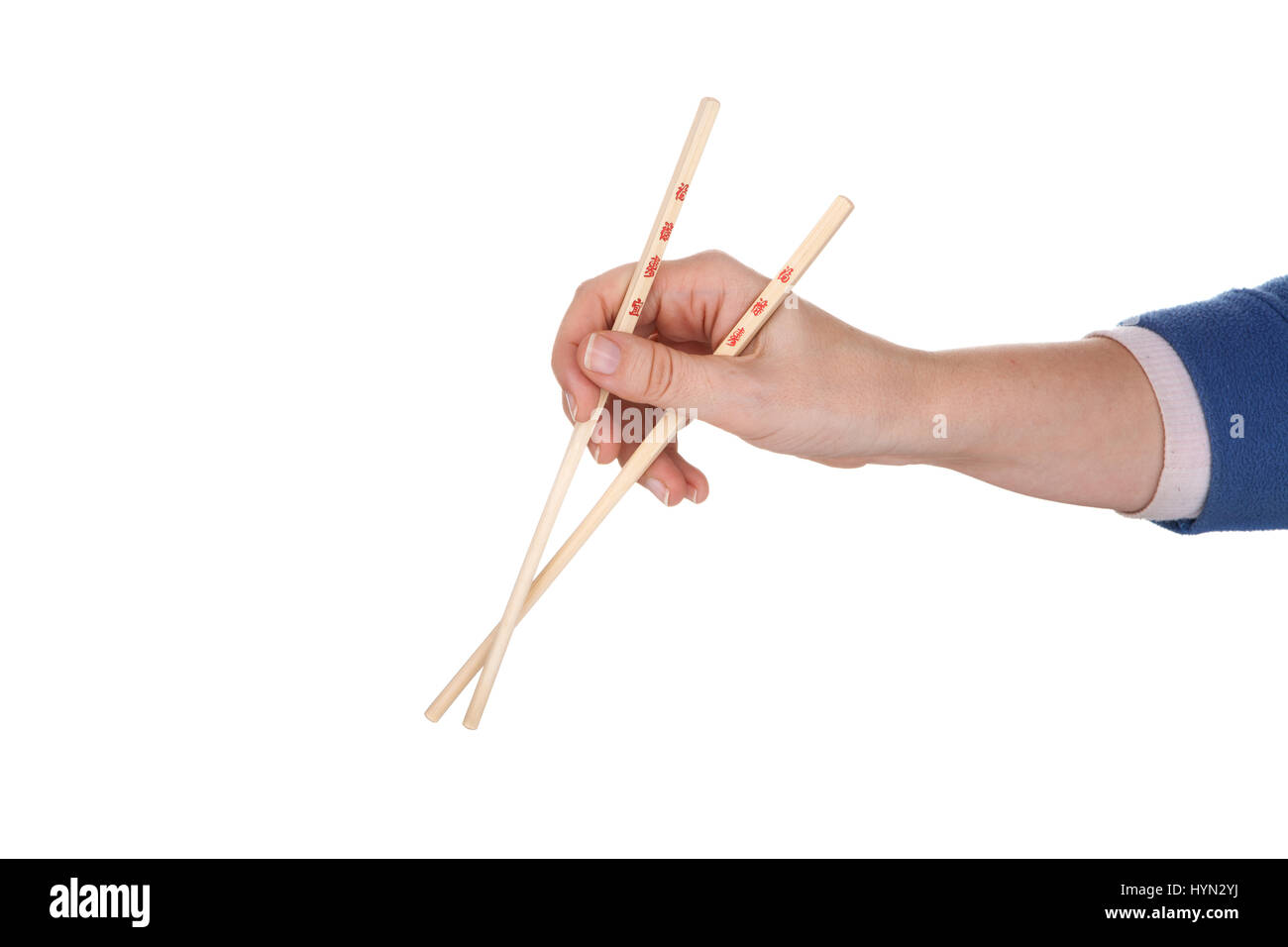 Female hand holding crossed chopsticks with chinese inscription Stock ...