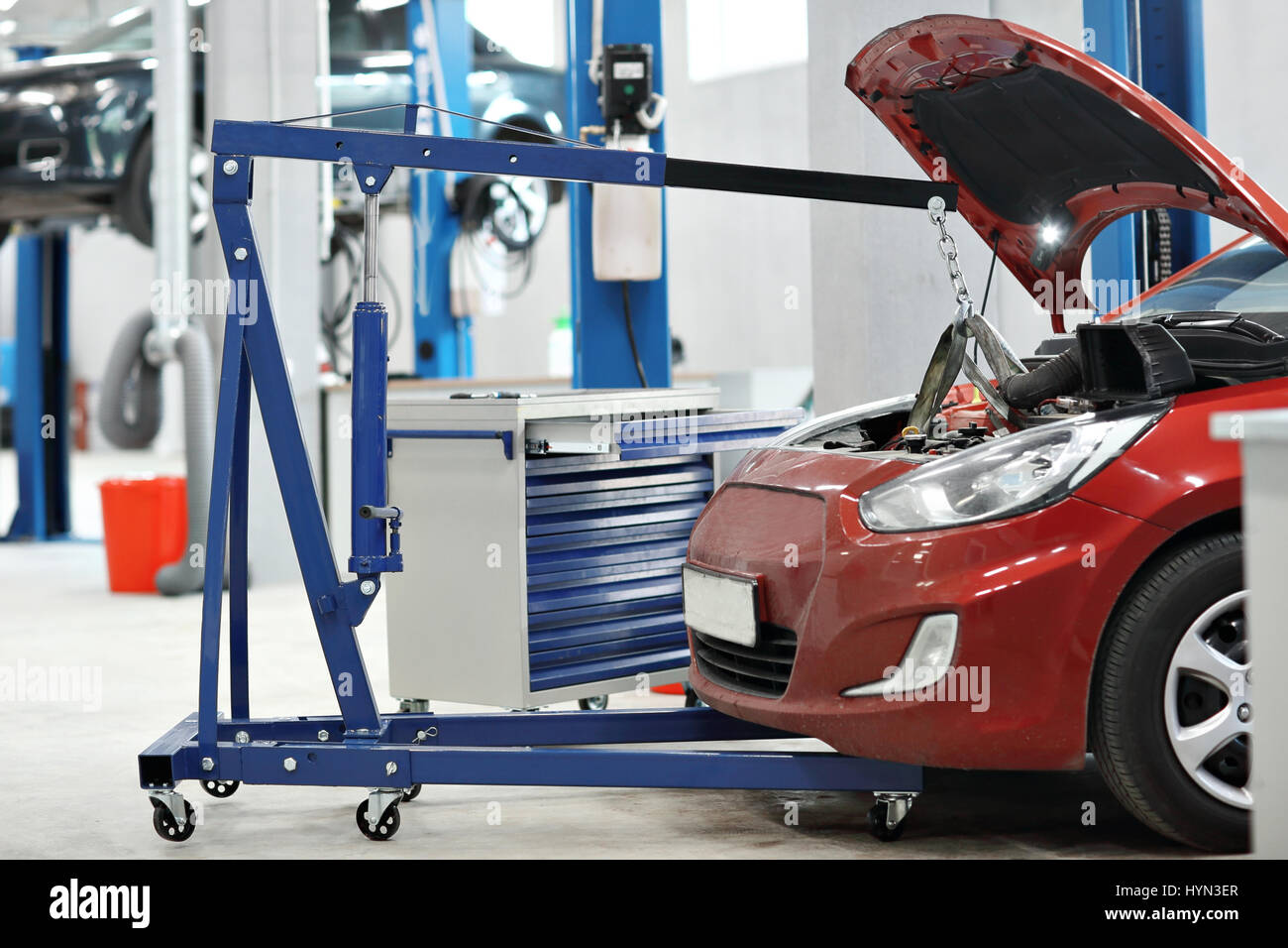 automobile mechanic a crane removed the engine from the car. repairing ...