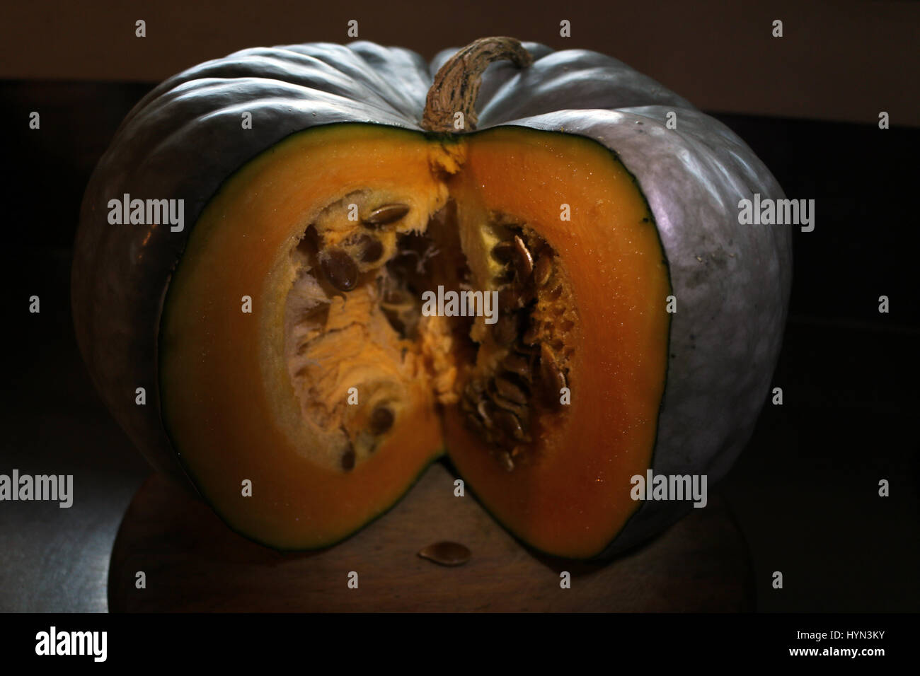 cut pumpkin showing inside flesh & seeds Stock Photo - Alamy