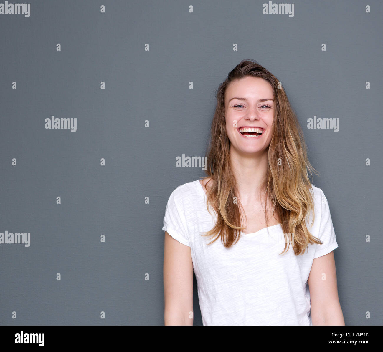 Close up portrait of a beautiful young woman laughing on fray ...