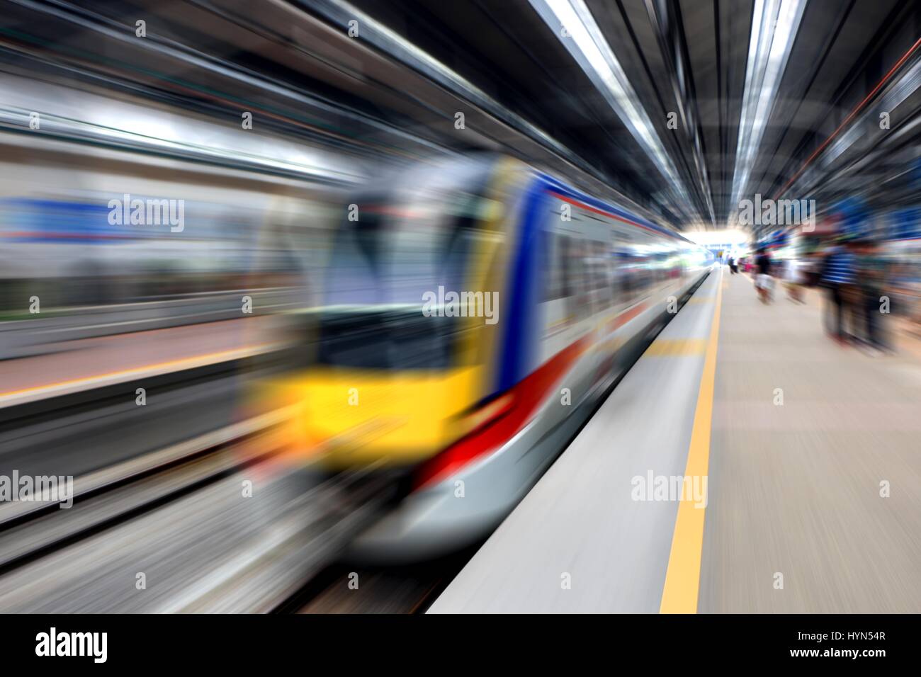 Fast train leaving station Stock Photo - Alamy