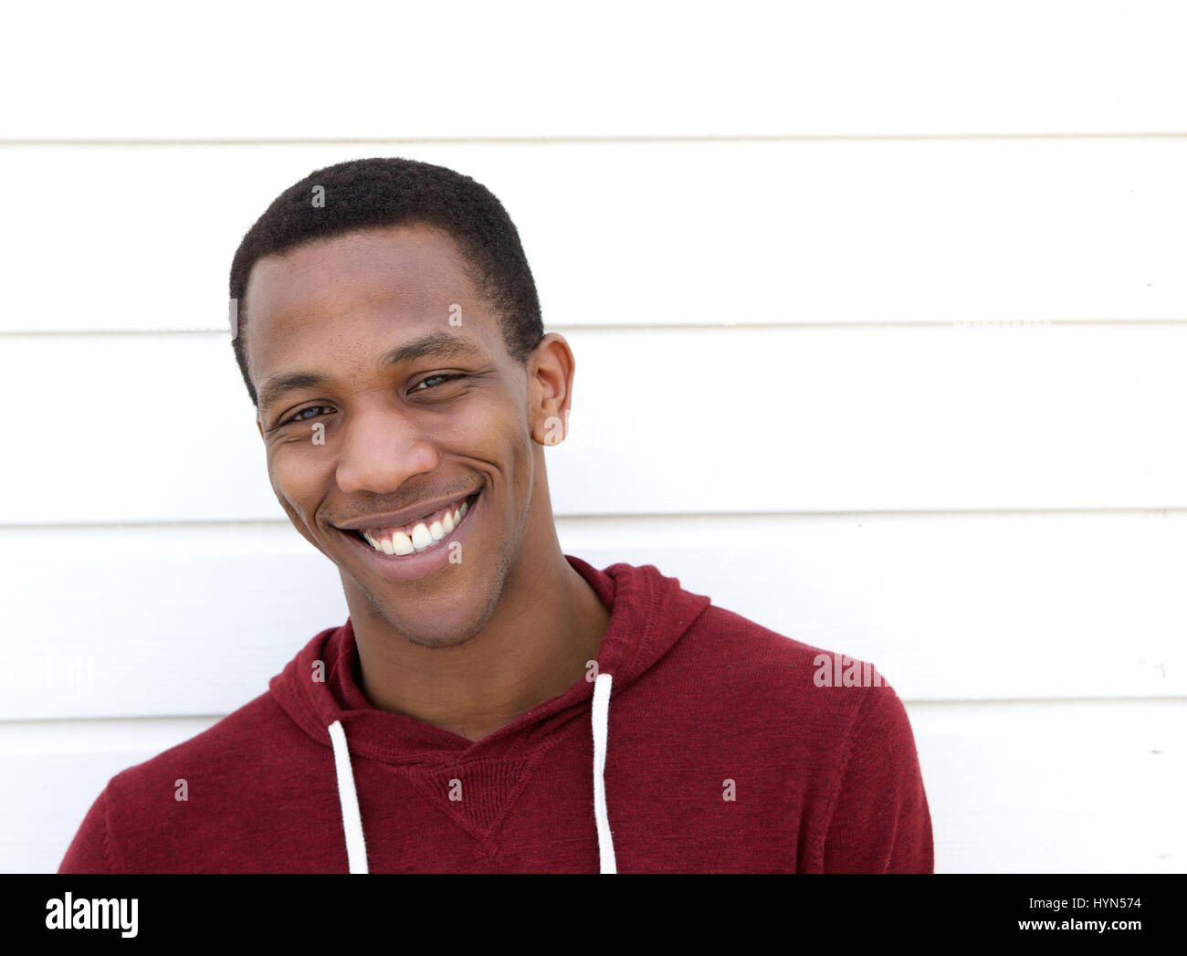 Close up portrait of a handsome african american man smiling on white ...