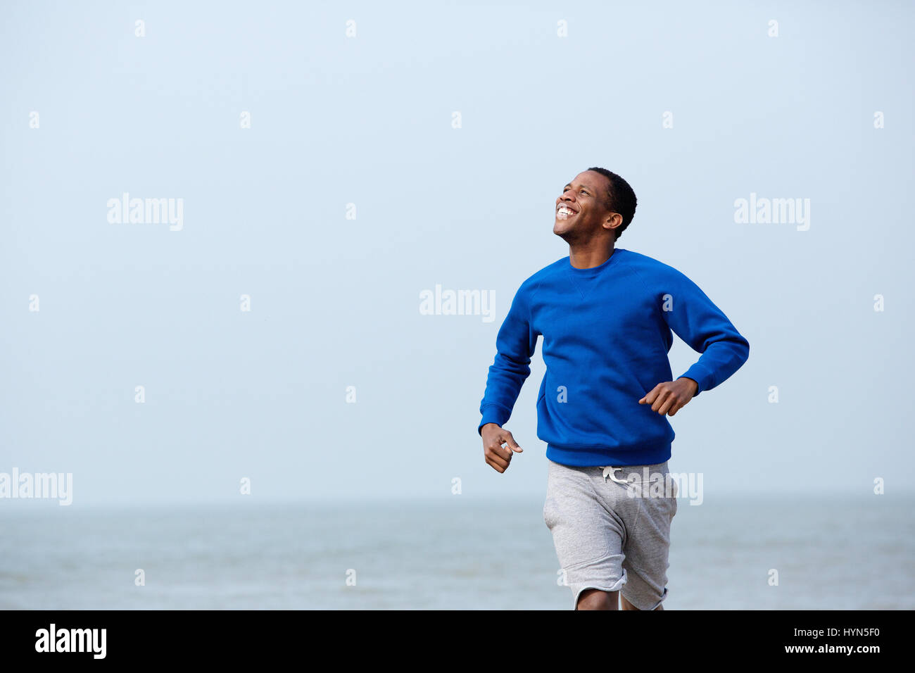 Handsome young athletic man jogging outdoors Stock Photo - Alamy