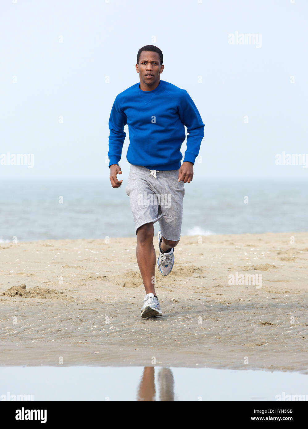 Black man jogging beach hi-res stock photography and images - Alamy