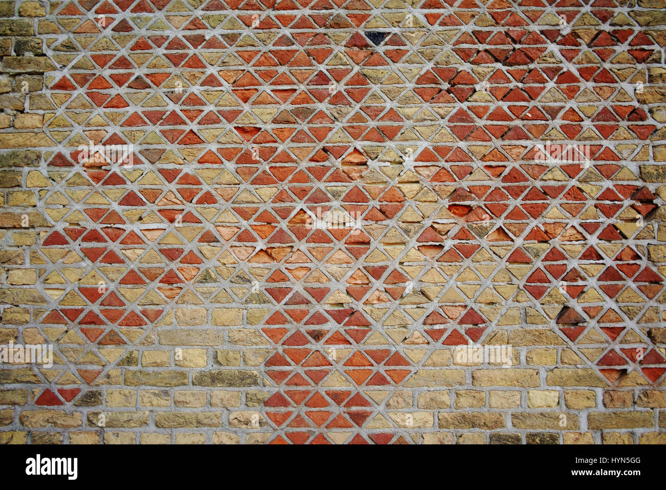 Abstract texture background of old triangle brick wall red and yellow ...