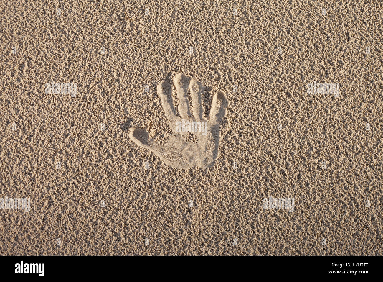 Handprint in sand Stock Photo - Alamy