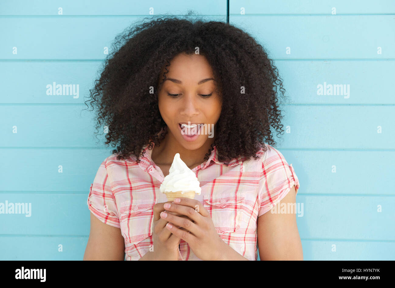 Close up portrait of a cute young woman looking surprised with ice ...