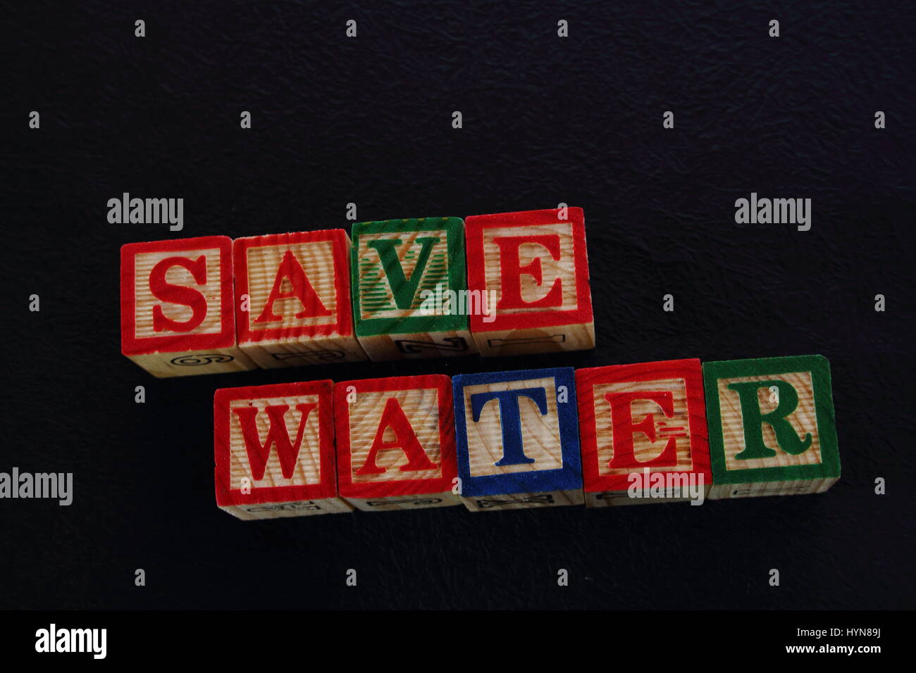 The term save water visually displayed on a black background using ...