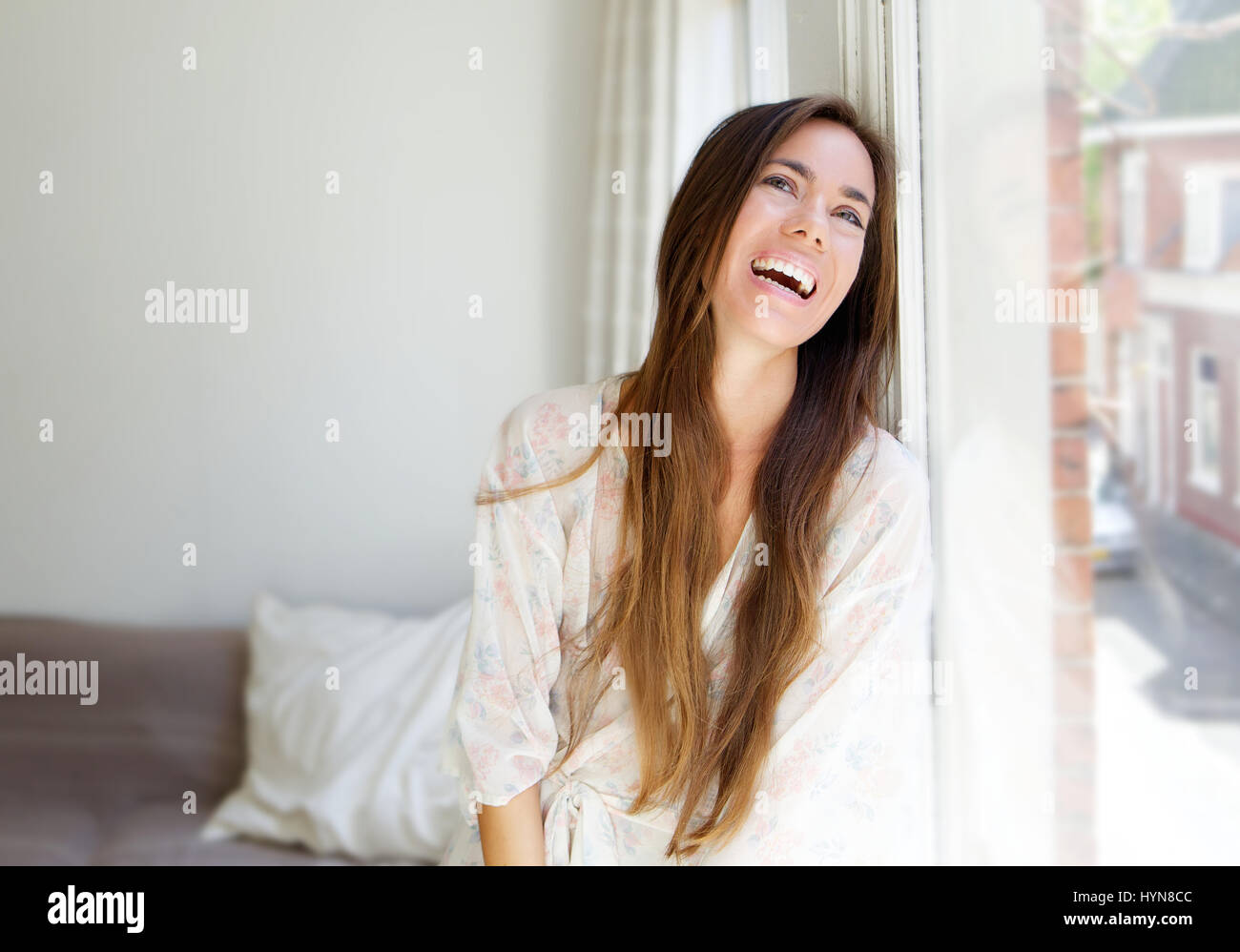 Woman next to window hi-res stock photography and images - Alamy