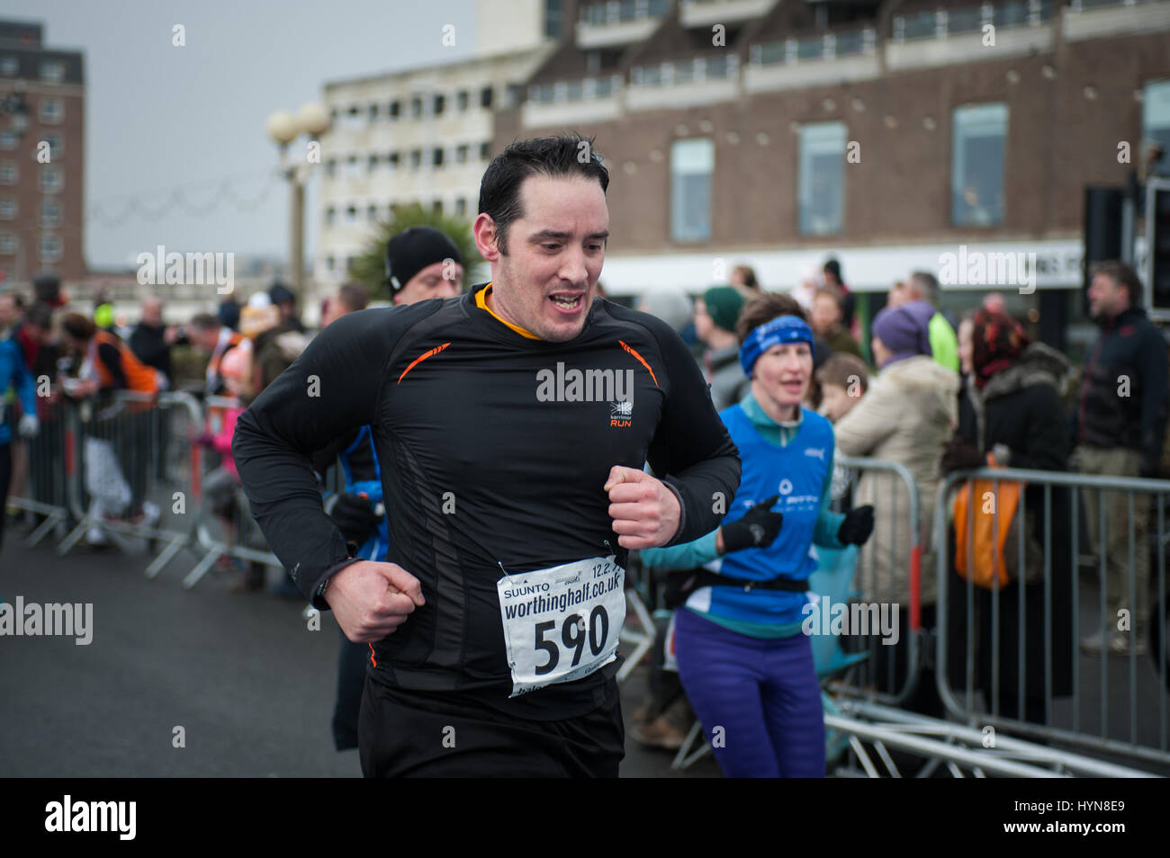 Tired and exhausted runners cross the finish line during the Worthing ...