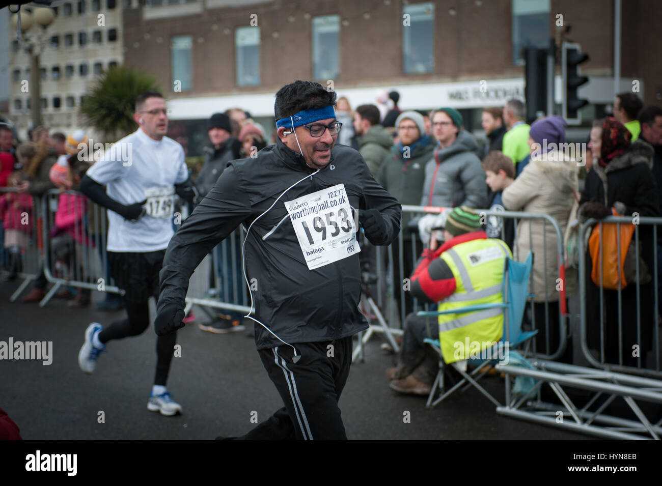 Tired and exhausted runners cross the finish line during the Worthing ...