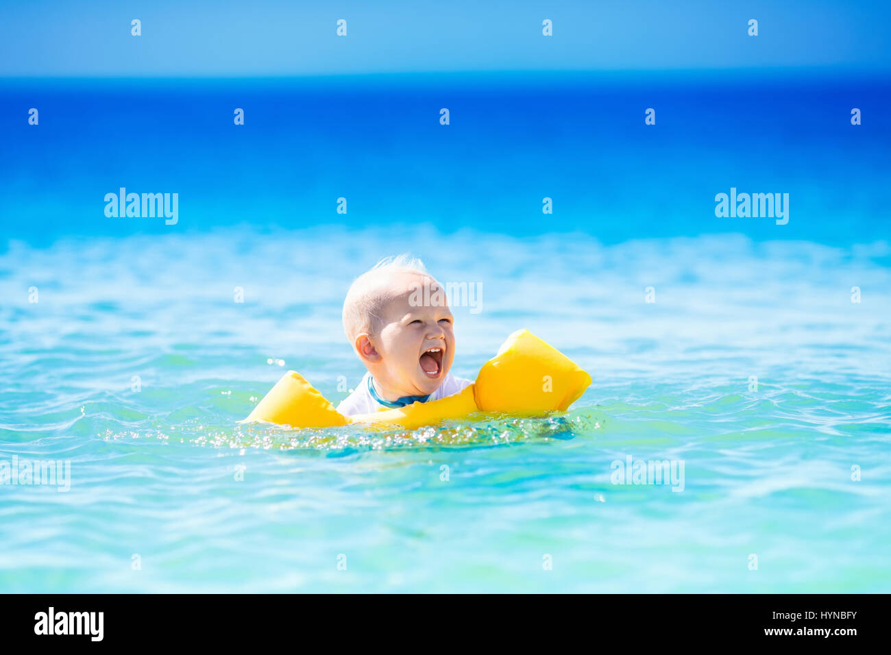 Child wearing water wings hi-res stock photography and images - Alamy